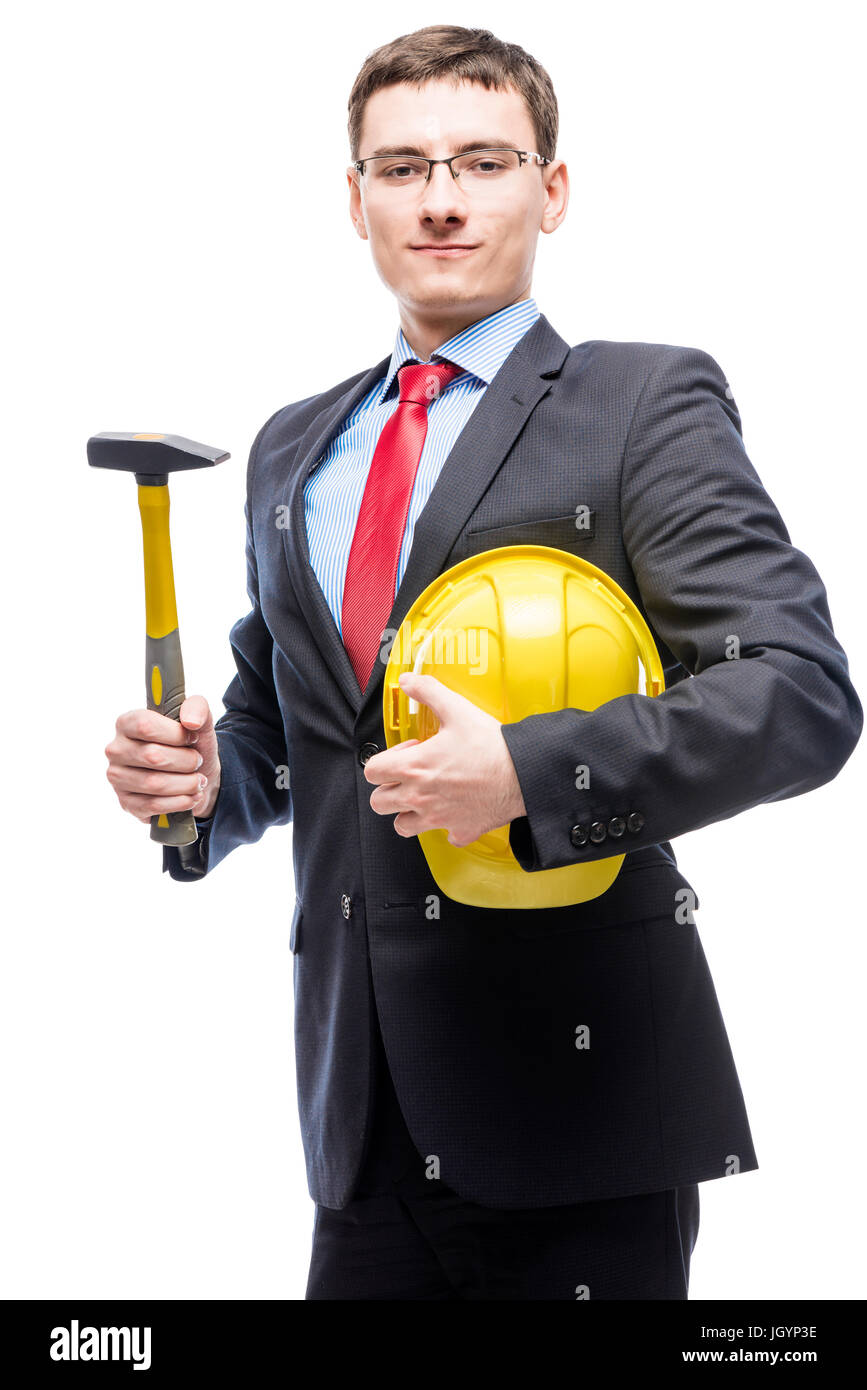 Architect in a suit with a hammer and construction helmet posing ...