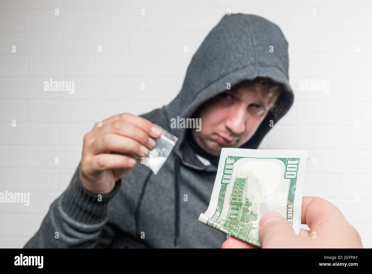 purchase drug dose from a drug dealer on the street, hand in close-up ...