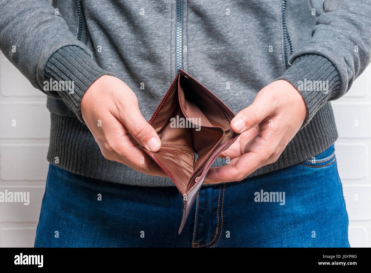 Close-up of empty purse in man's hands Stock Photo - Alamy