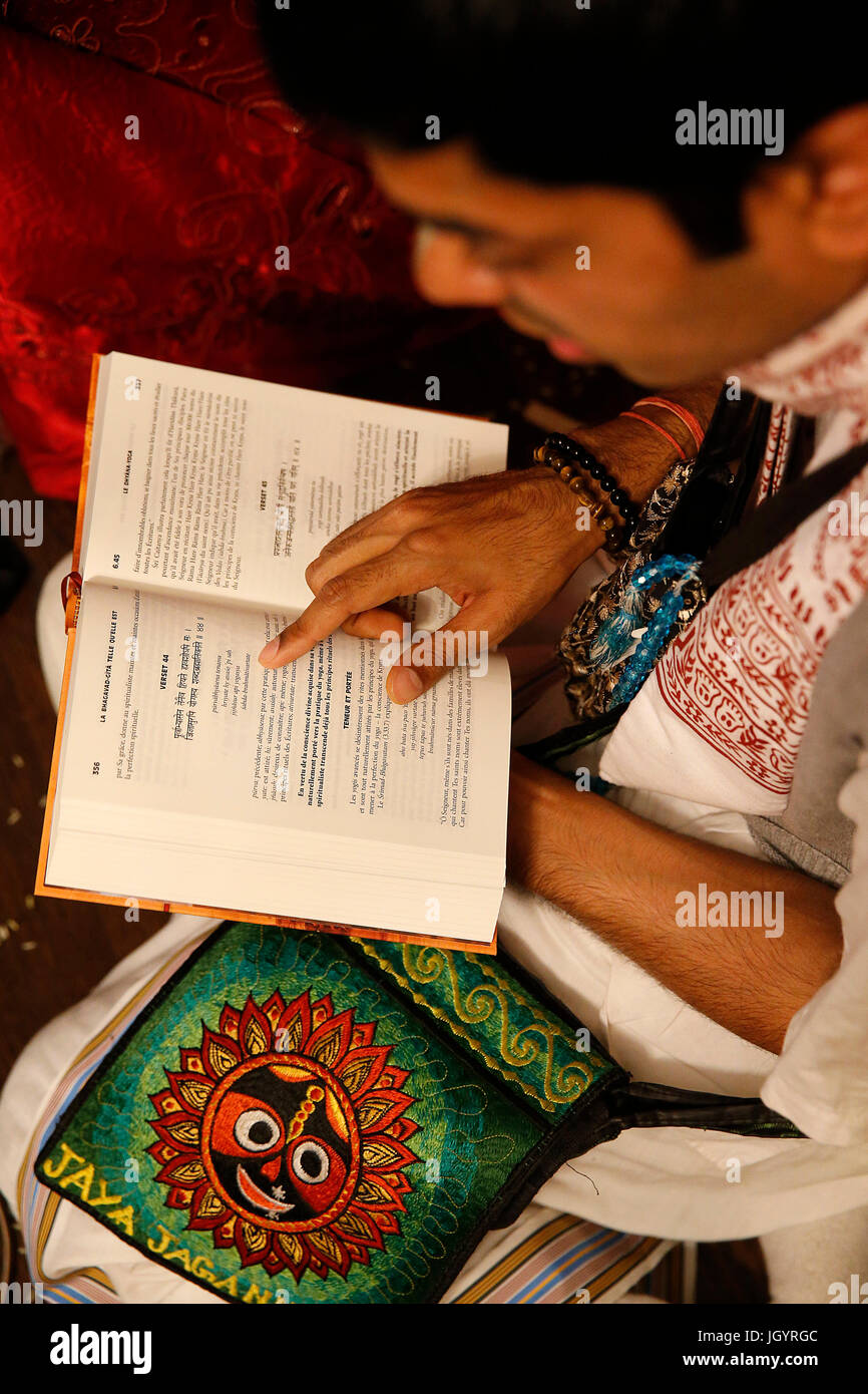 Gita Jayanti celebration in an ISKCON temple. Devotee reading the ...