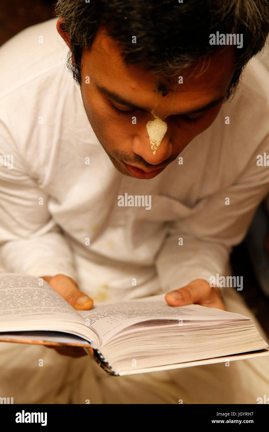Gita Jayanti celebration in an ISKCON temple. Devotee reading the ...