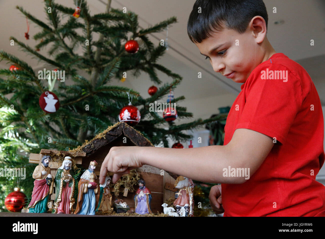 10-year-old boy laying a Christmas nativity scene. France Stock Photo ...