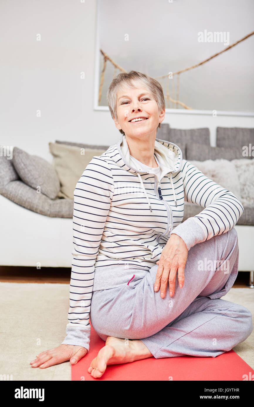 Senior at home stretching hi-res stock photography and images - Alamy