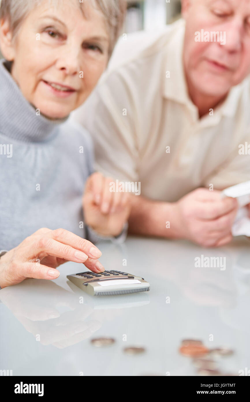 Senior woman using calculator with husband for home accounting Stock ...