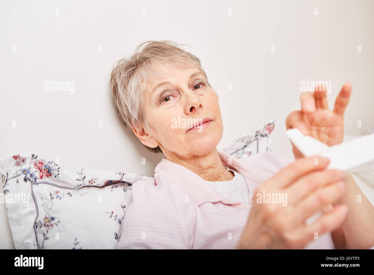 Senior sick woman taking tablets out of pill dispenser Stock Photo - Alamy