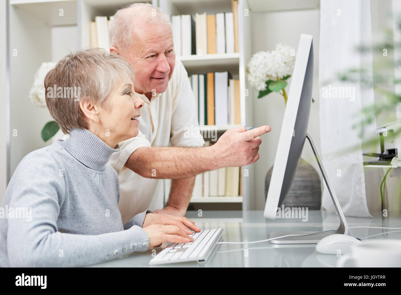 Senior citizens as couple learn about computer and online support Stock ...