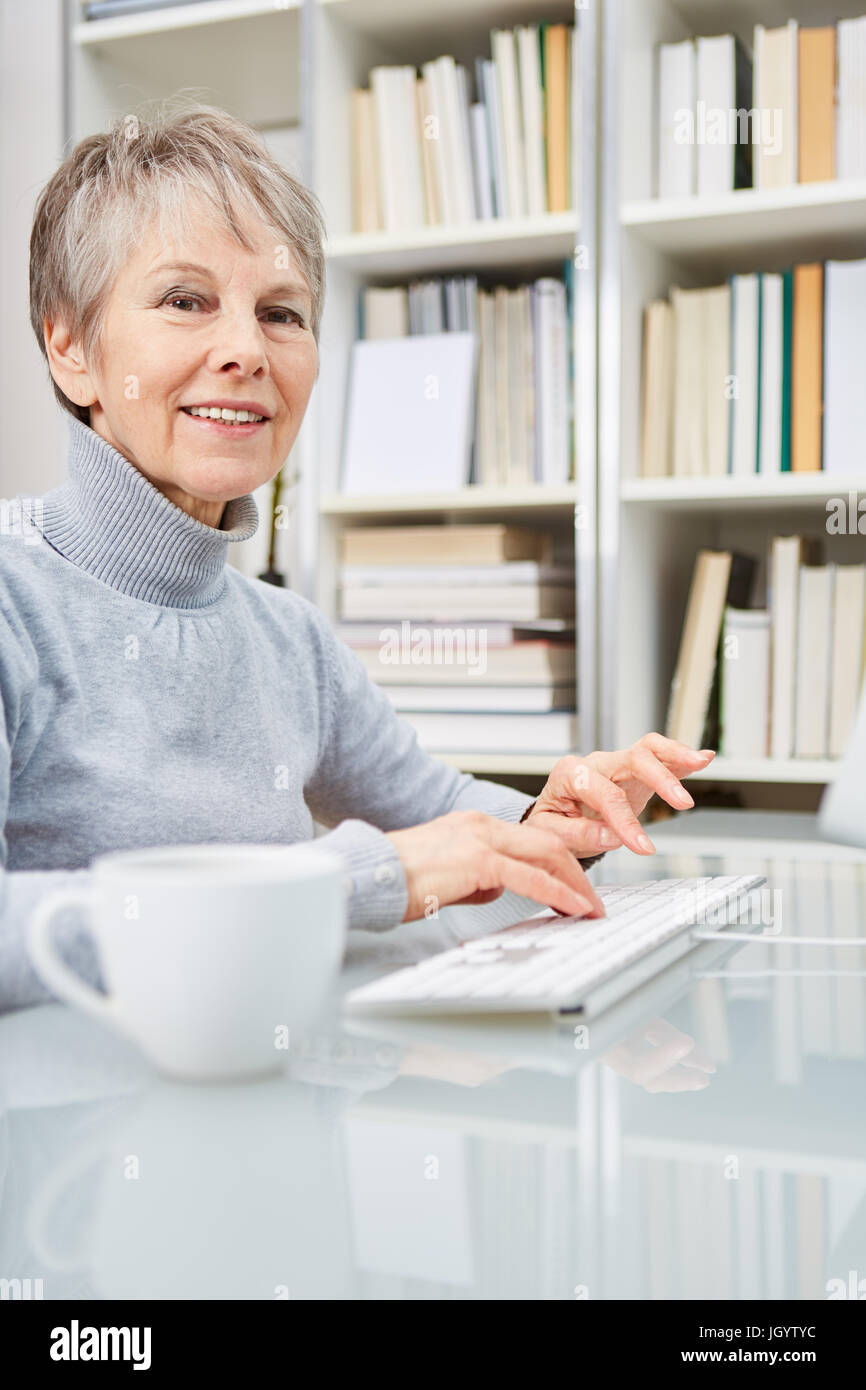 Old woman working at computer hi-res stock photography and images - Alamy