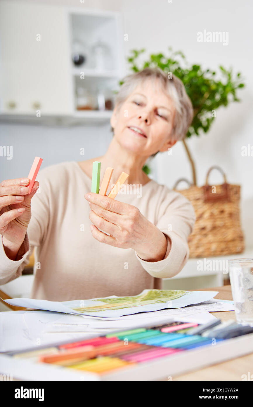 Senior citizen painting with chalk as therapy for dementia Stock Photo ...