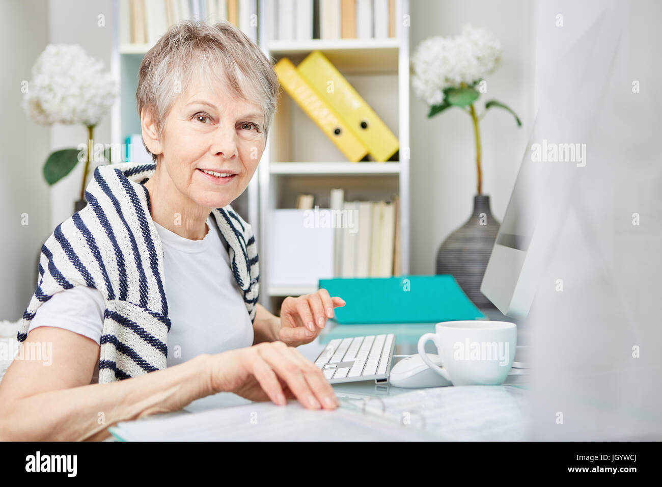Senior businesswoman at her office working on accounting Stock Photo ...