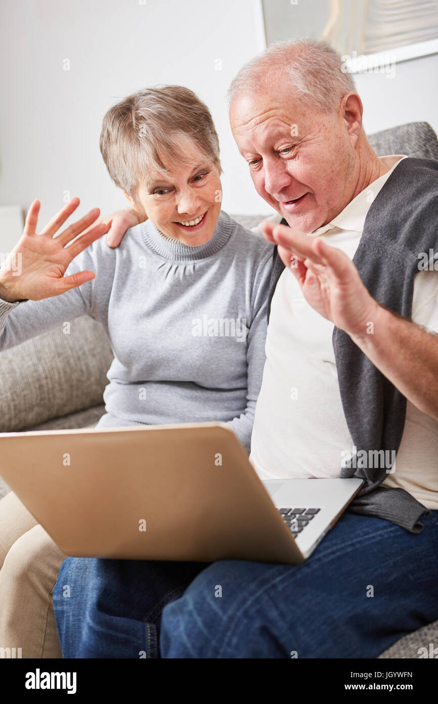 Video chat with two senior citizens waving happy at computer Stock ...