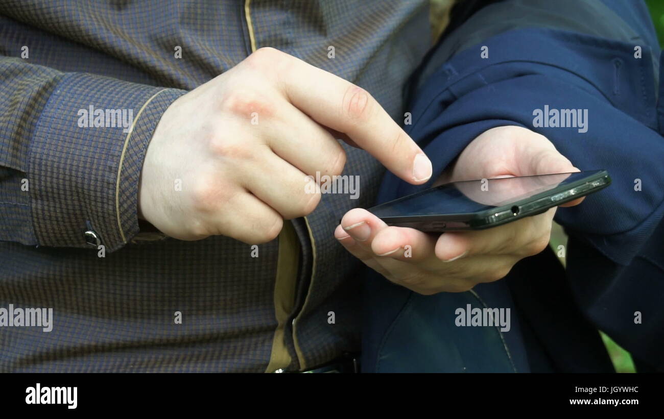 young businessman typing message on the phone Stock Photo - Alamy