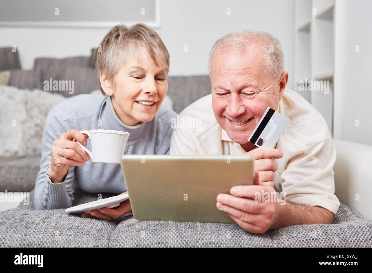 Two seniors shopping online with tablet making a card payment Stock ...