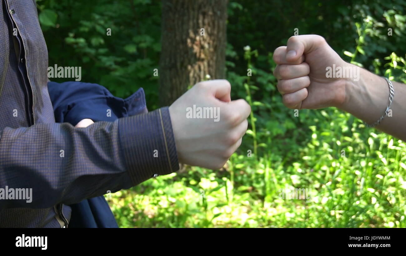 Rock, scissors, paper is played by two young man in the forest, high ...