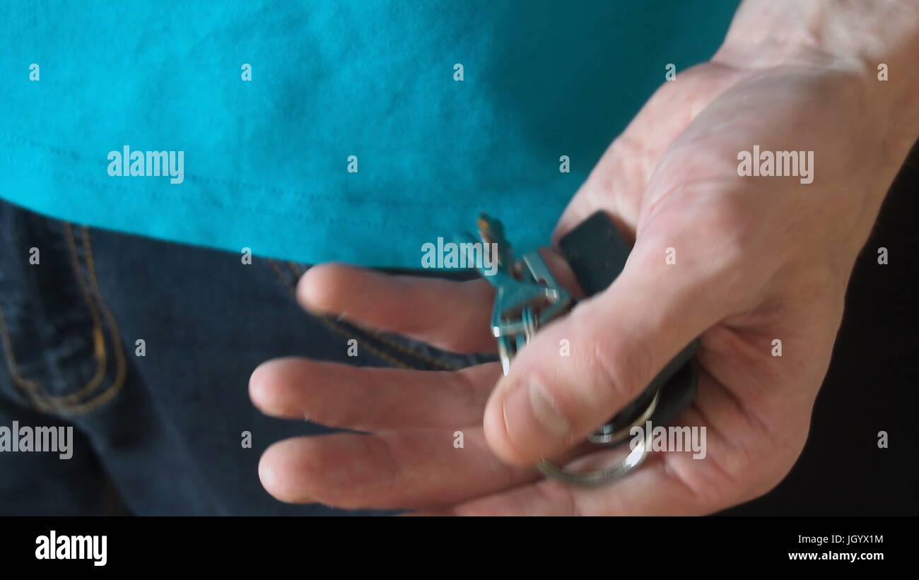 the young man puts the keys in your pocket Stock Photo - Alamy