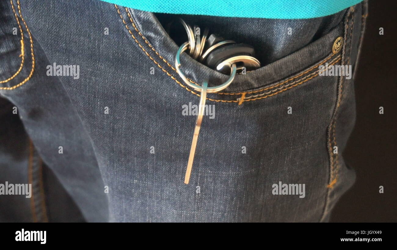 the young man pulls the keys from his pocket Stock Photo - Alamy