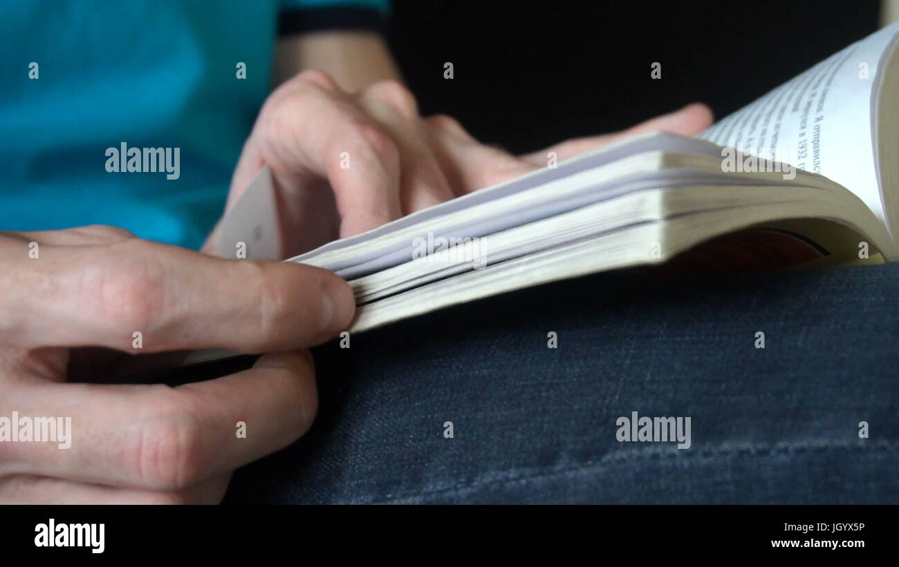 young man reading a book, leafing through pages,slow motion Stock Photo ...