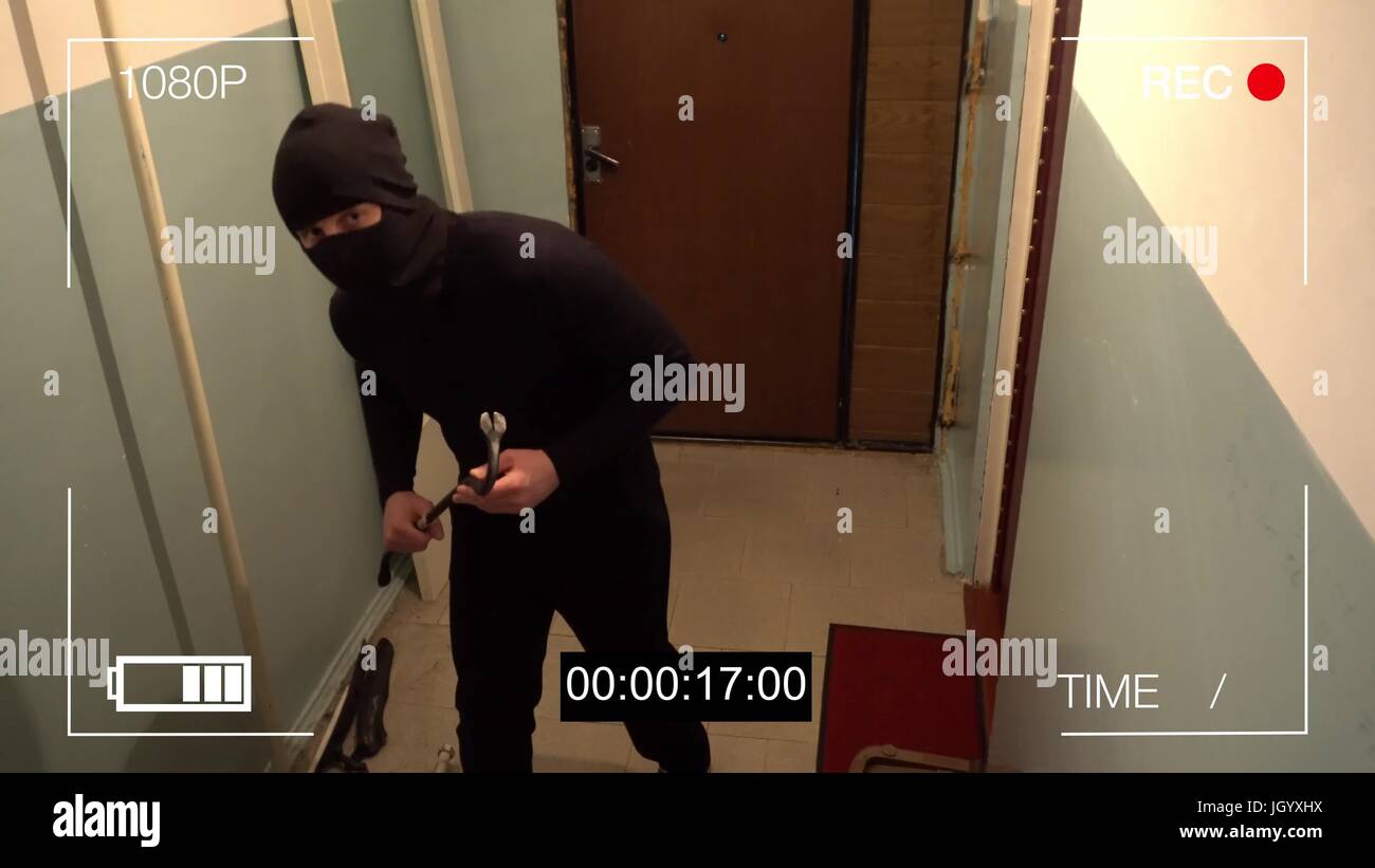 the masked robber burst through the door and broke the security camera ...