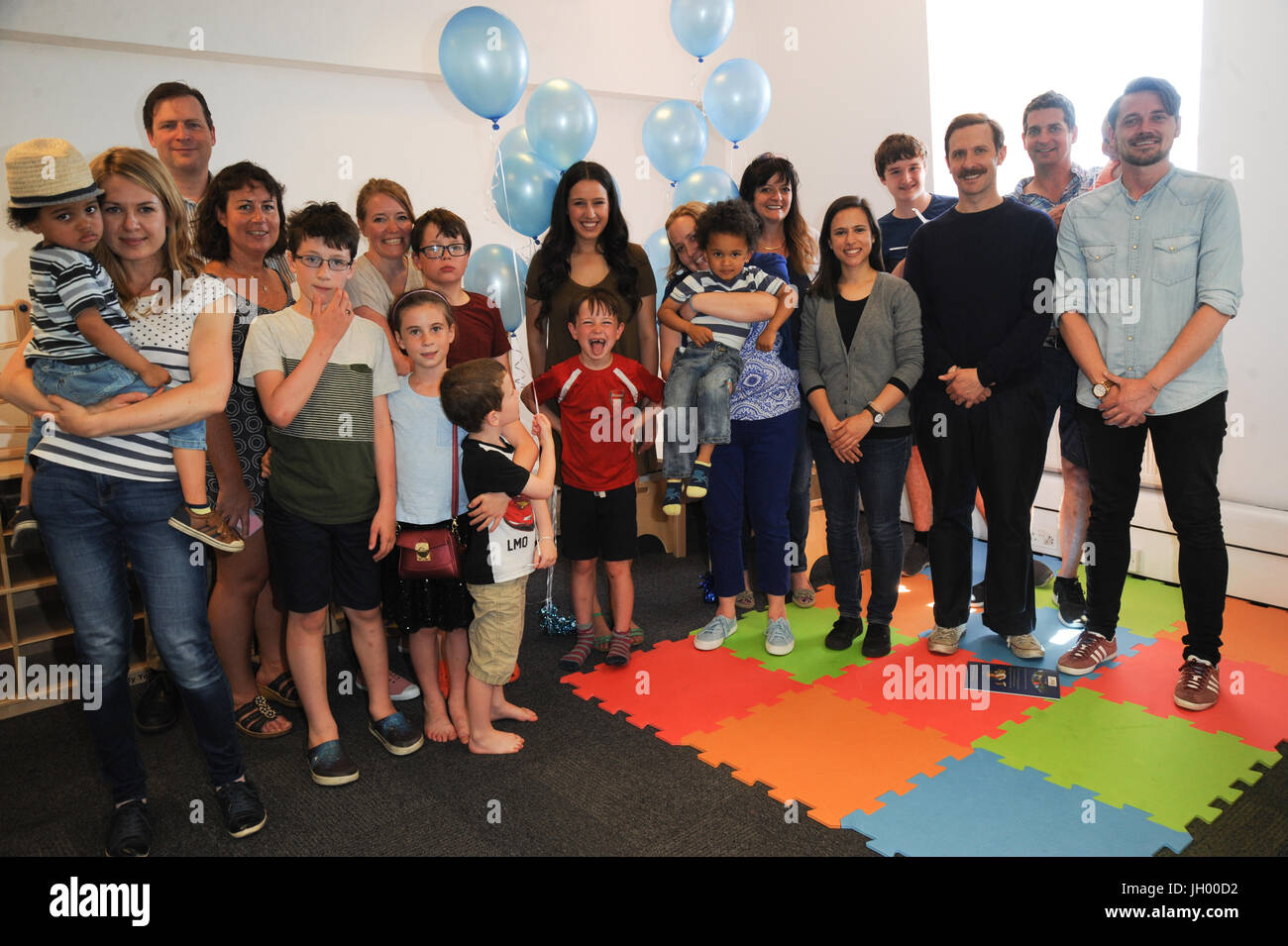 Staff and families and children using the chartiy project hi-res stock ...