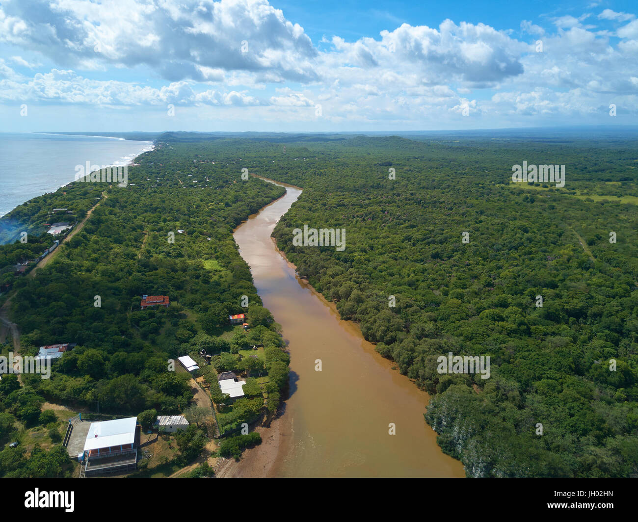 Brown river flow next to ocean aerial above view Stock Photo - Alamy