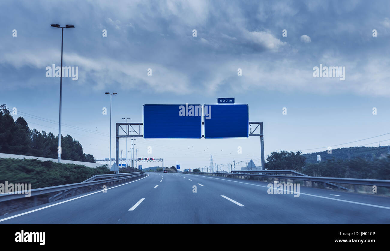 Empty blue speedway direction signs Stock Photo - Alamy
