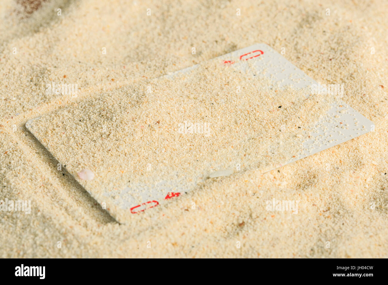 Poker playing cards buried in a sand dune Stock Photo - Alamy
