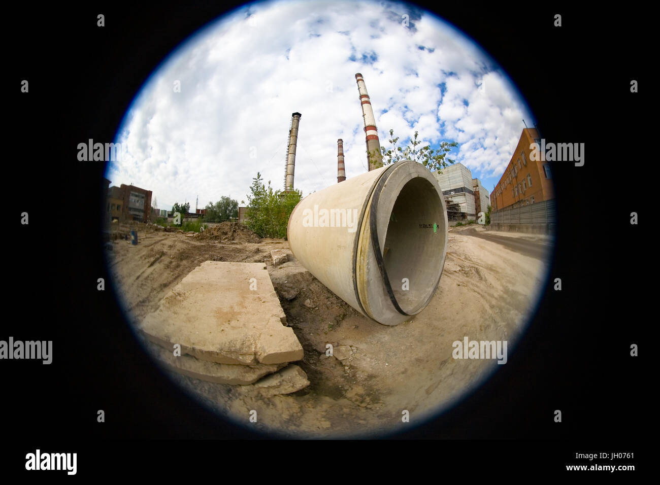 Ultra-wide angle. Industrial landscape with pipes and concrete slabs ...