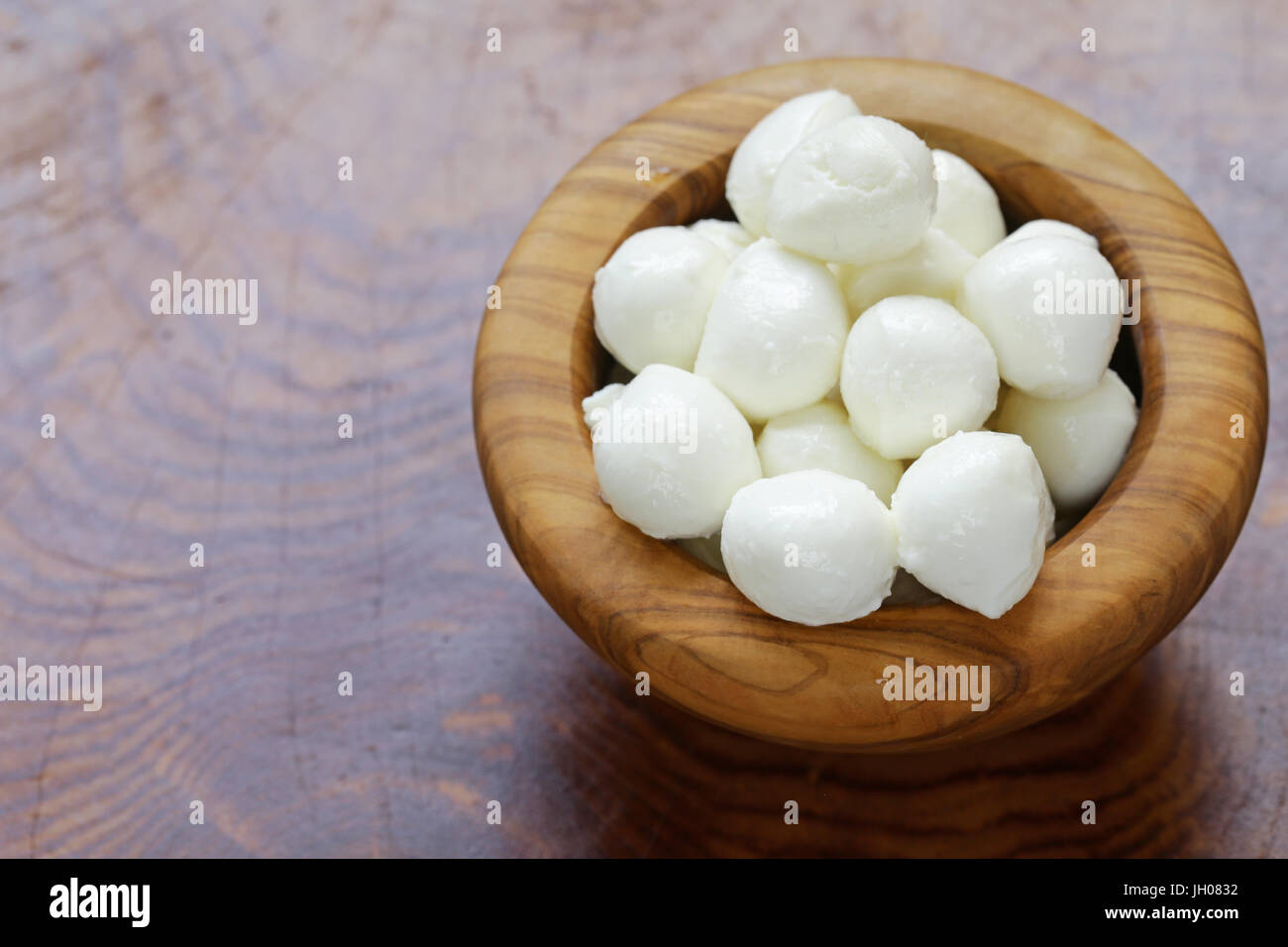 Italian soft mozzarella cheese on a wooden table Stock Photo - Alamy