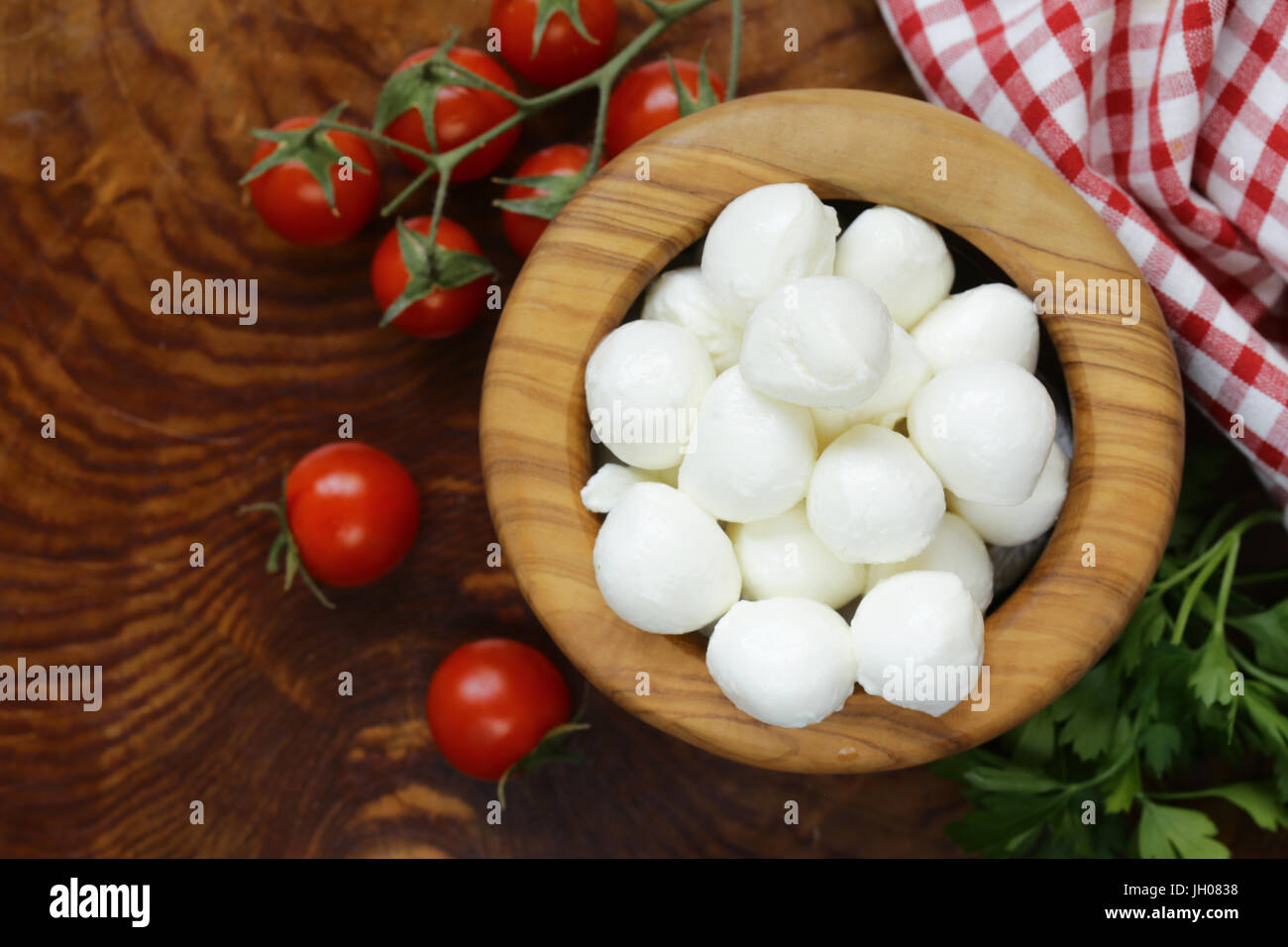 Italian soft mozzarella cheese on a wooden table Stock Photo - Alamy
