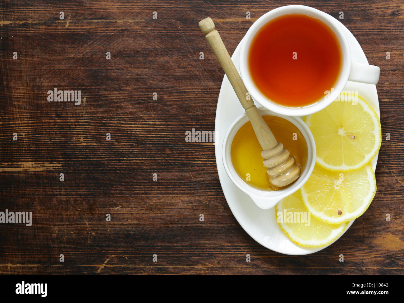 Black tea with lemon and honey, warming winter drink Stock Photo - Alamy