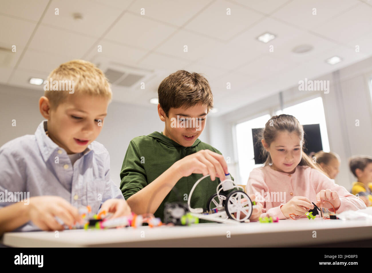 happy children building robots at robotics school Stock Photo - Alamy