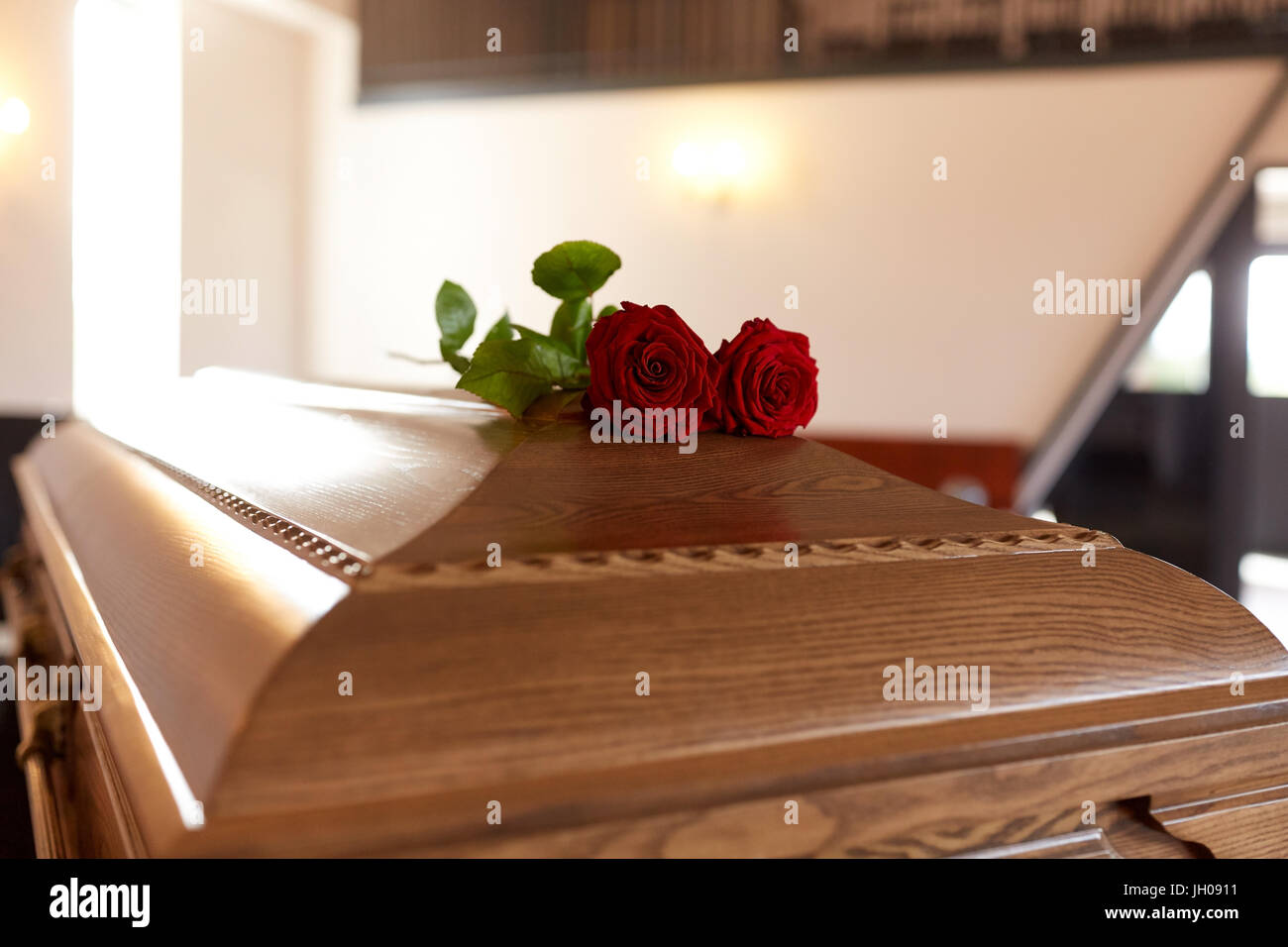 red rose flowers on wooden coffin in church Stock Photo - Alamy