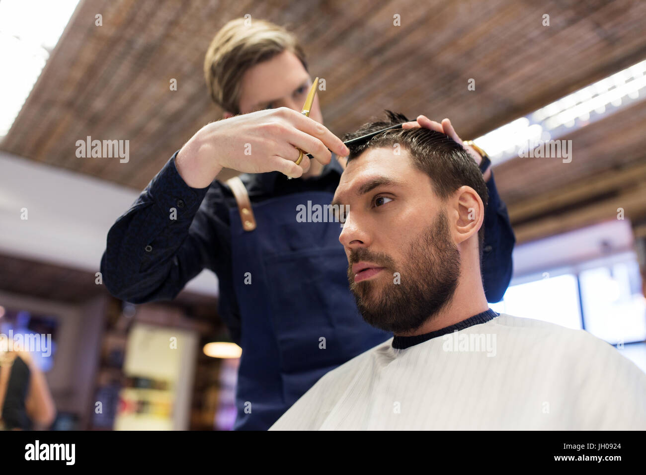 man and barber cutting hair at barbershop Stock Photo - Alamy