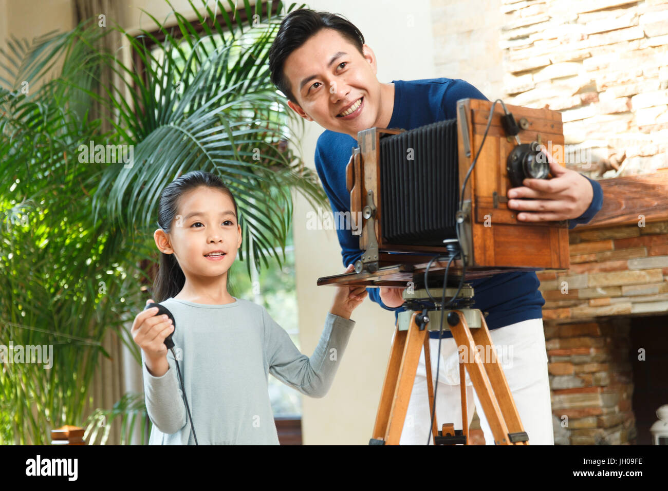 Father and daughter with old-fashioned camera Stock Photo - Alamy