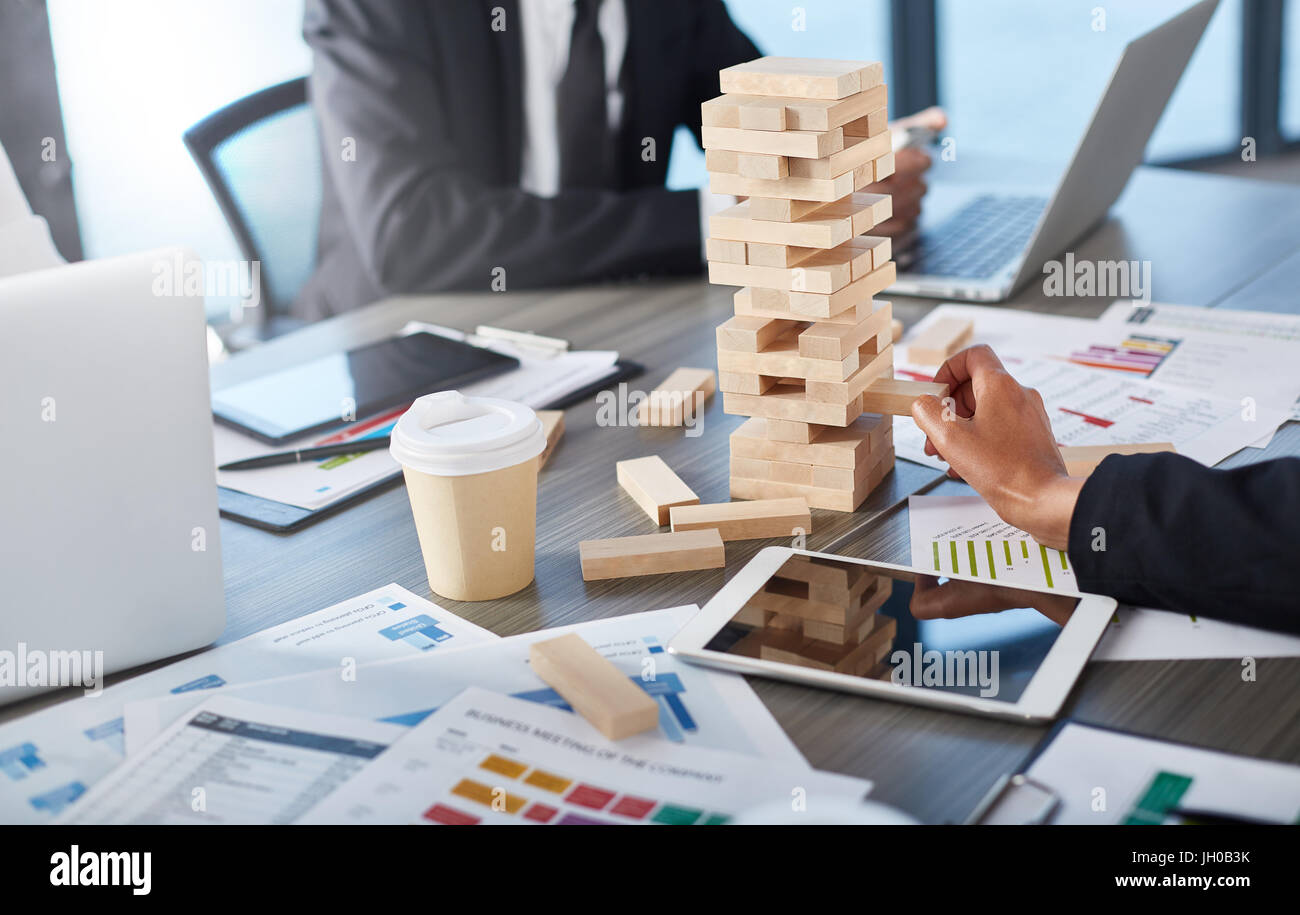 Team of business people build a wooden construction. concept of ...