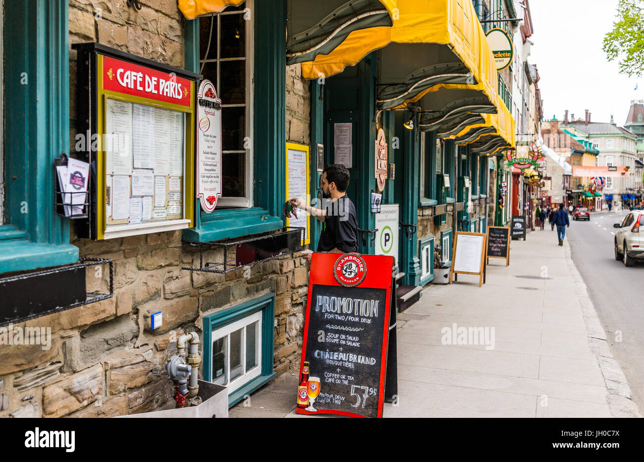 Quebec City, Canada - May 29, 2017: Employee man waiter cleaning window ...