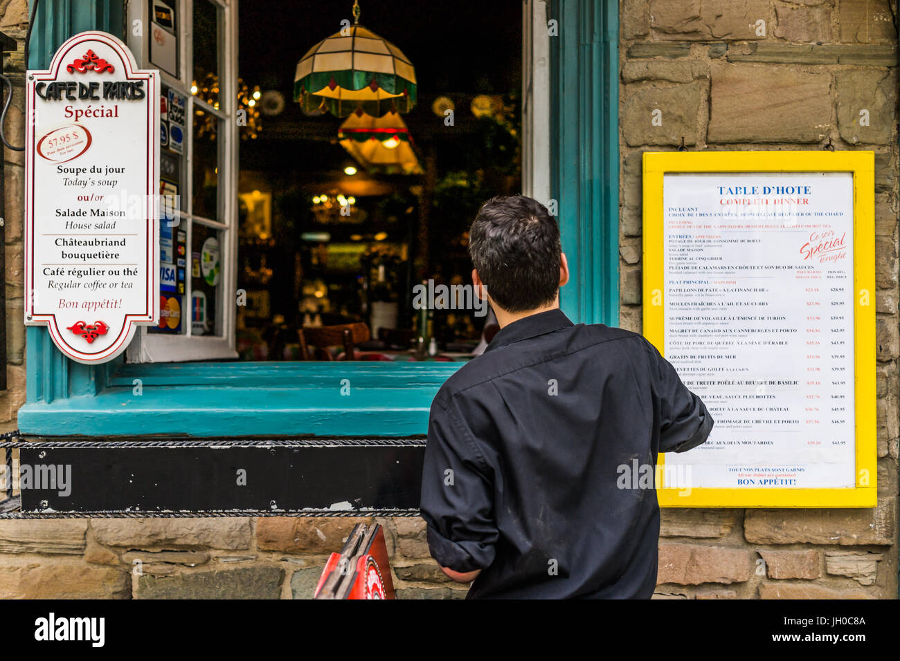 Quebec City, Canada - May 29, 2017: Employee man waiter cleaning window ...