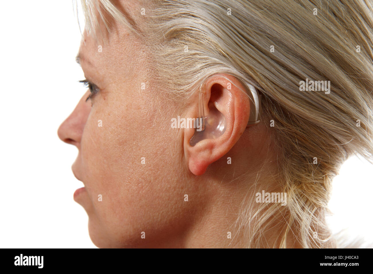 modern digital hearing aid in woman's ear Stock Photo - Alamy