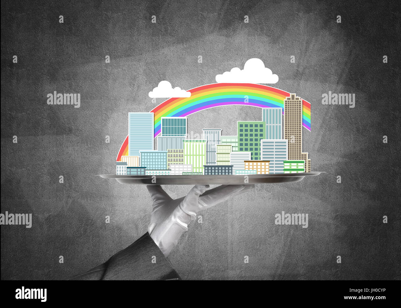 Hand holding metal tray with modern city model against concrete ...