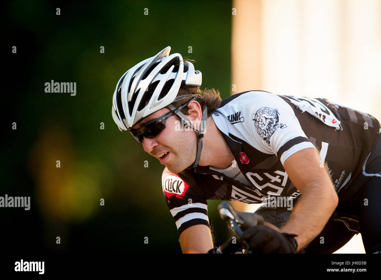 An athletic young male cyclist competes in an urban road race Stock ...