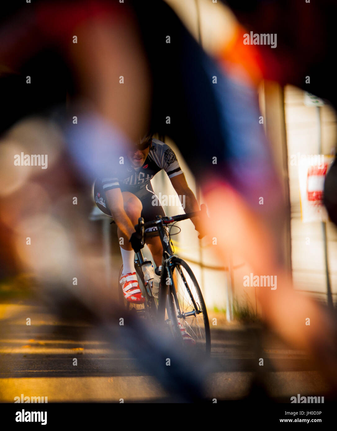 An athletic young male cyclist competes in an urban road race Stock ...