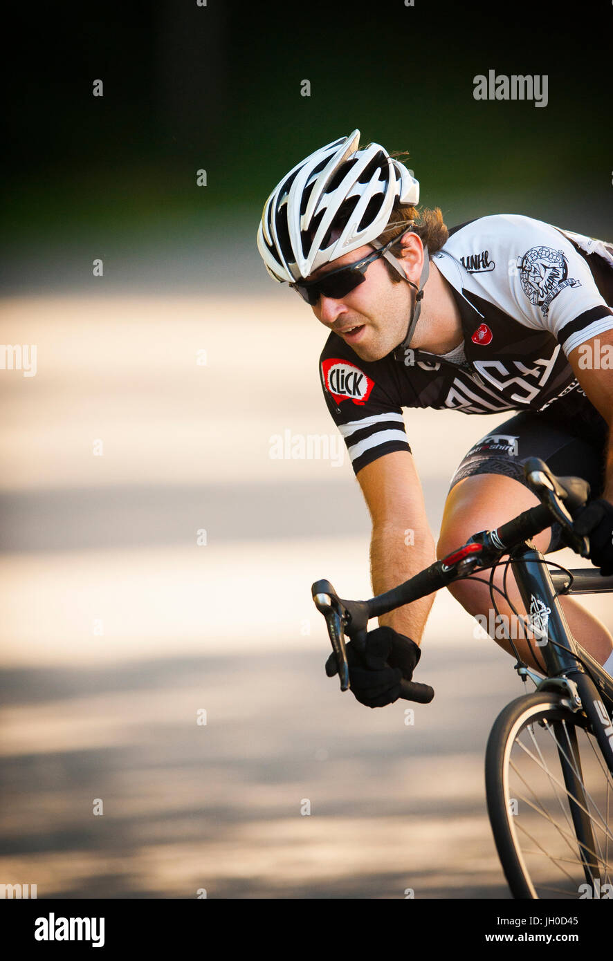 An athletic young male cyclist competes in an urban road race Stock ...