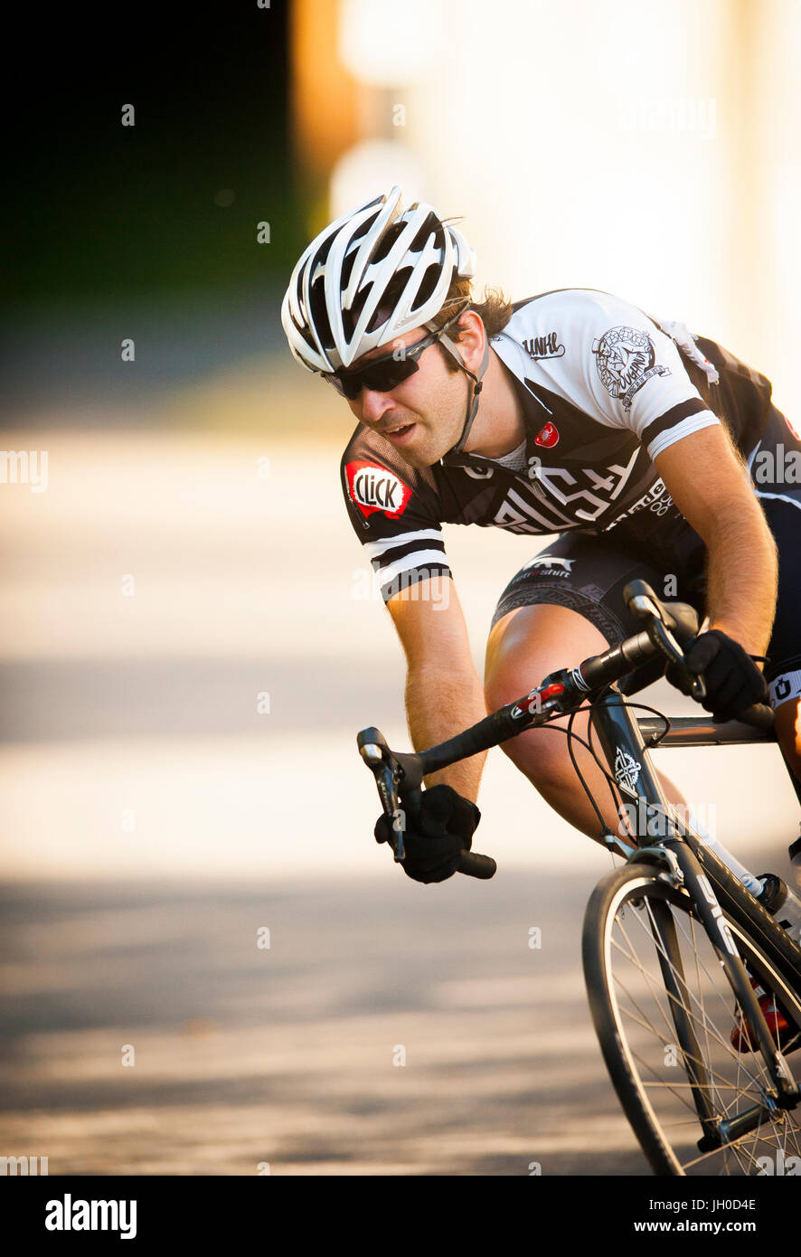 An athletic young male cyclist competes in an urban road race Stock ...