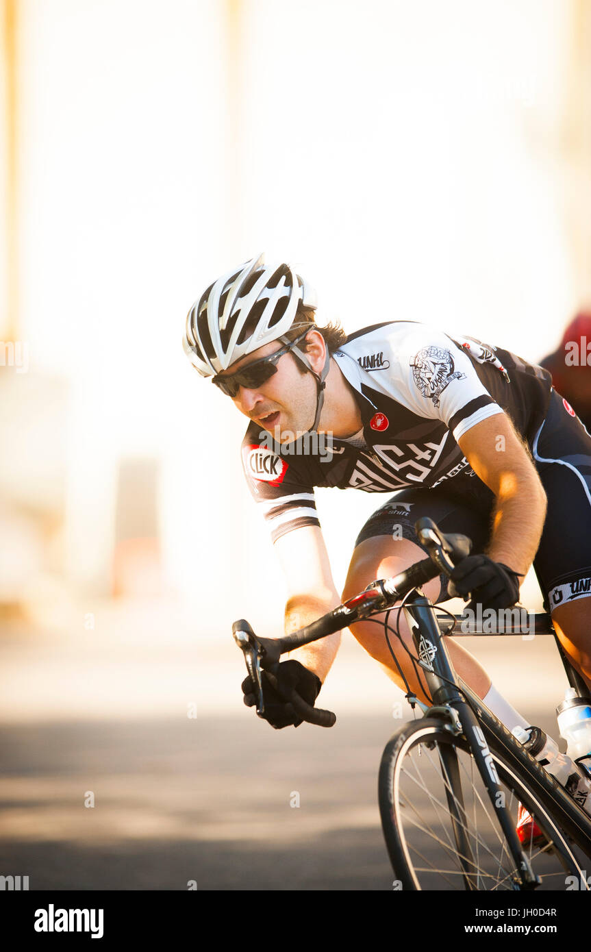 An athletic young male cyclist competes in an urban road race Stock ...