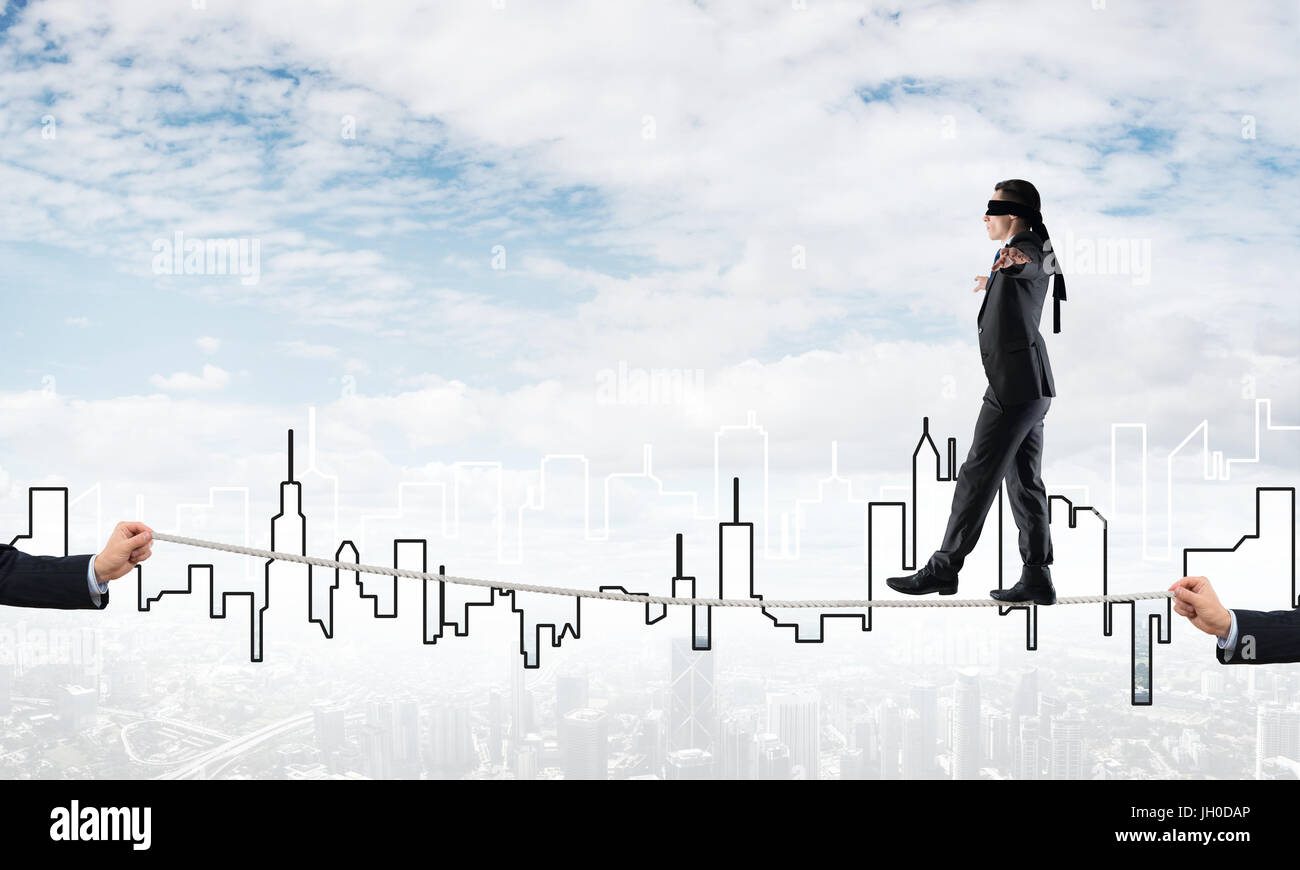 Business concept of risk support and assistance with man balancing on ...