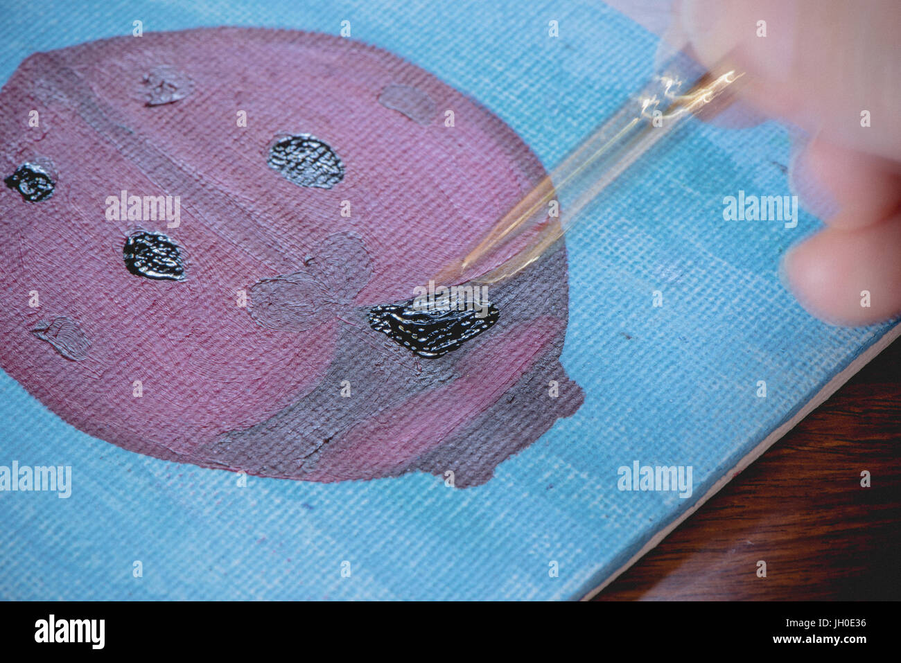 Motion of hand painting a ladybird with motion blur Stock Photo - Alamy