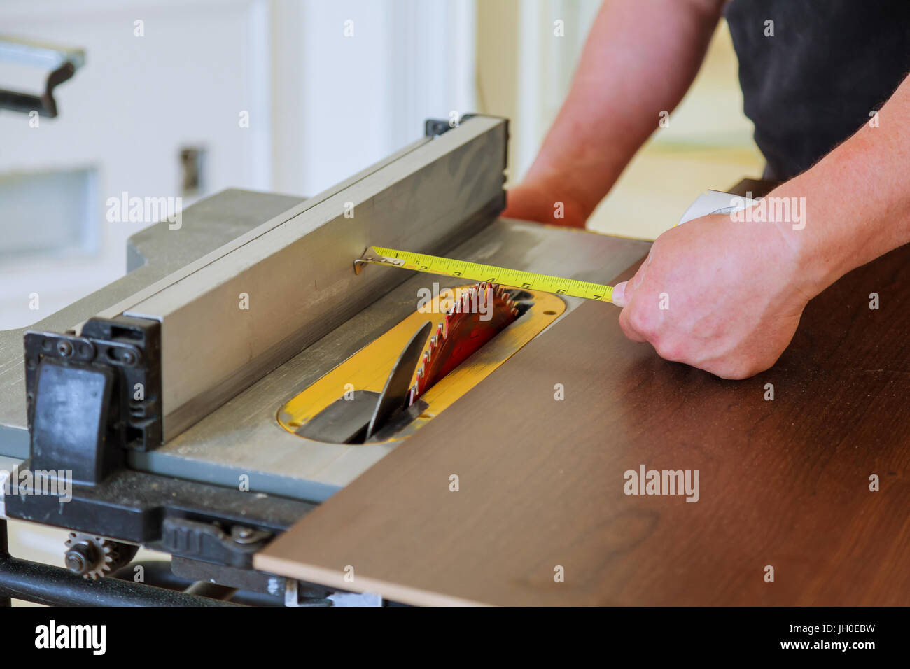 Carpenter using table saw cutting wood. handyman cutting plywood on ...