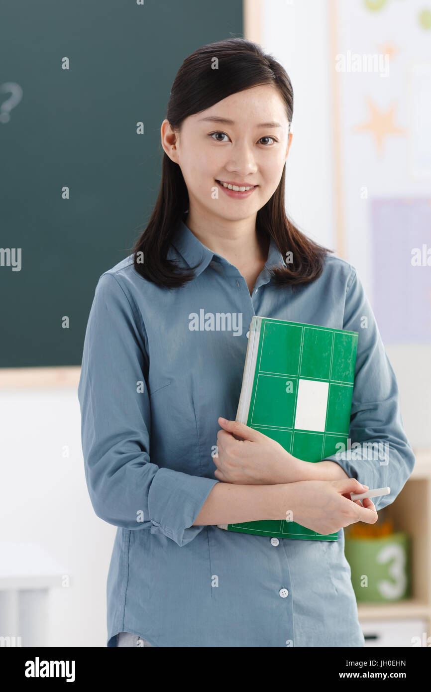 Portrait of young female teacher Stock Photo - Alamy