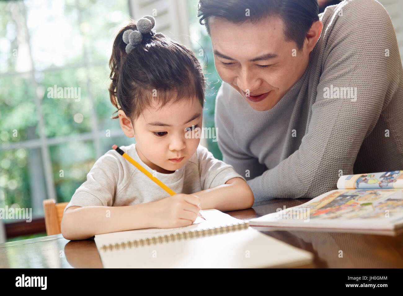 Father helping daughter with her study Stock Photo - Alamy