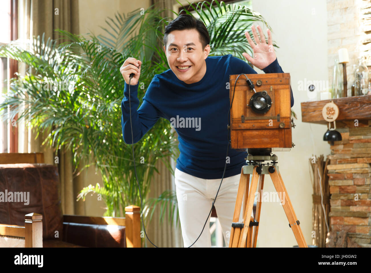 Young man taking photograph with an old-fashioned camera Stock Photo ...