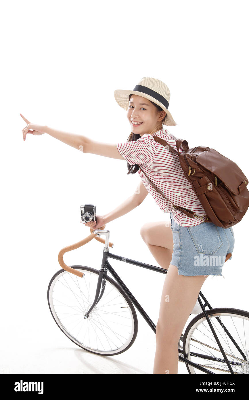 Young woman riding bicycle Stock Photo - Alamy